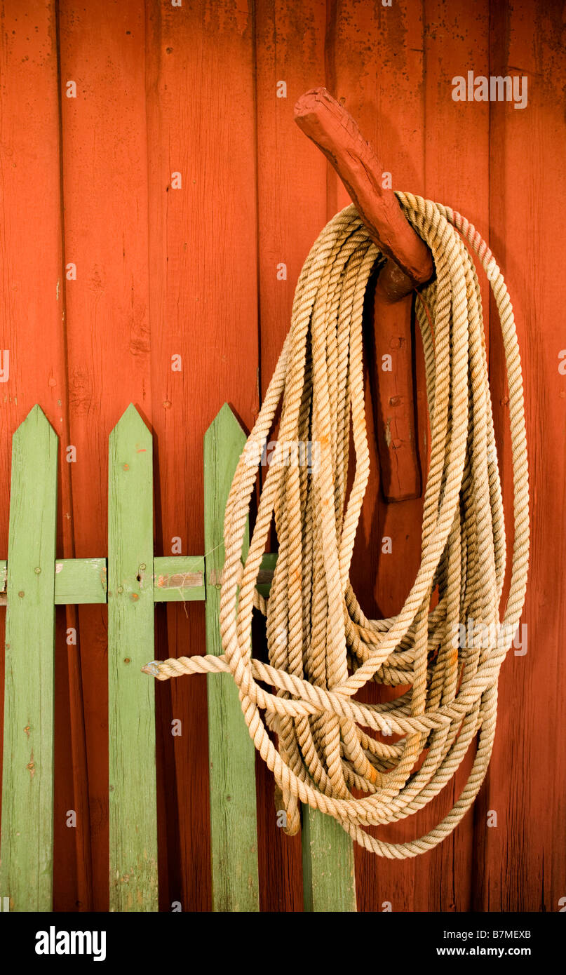 rope hanging on the wooden red wall Stock Photo - Alamy