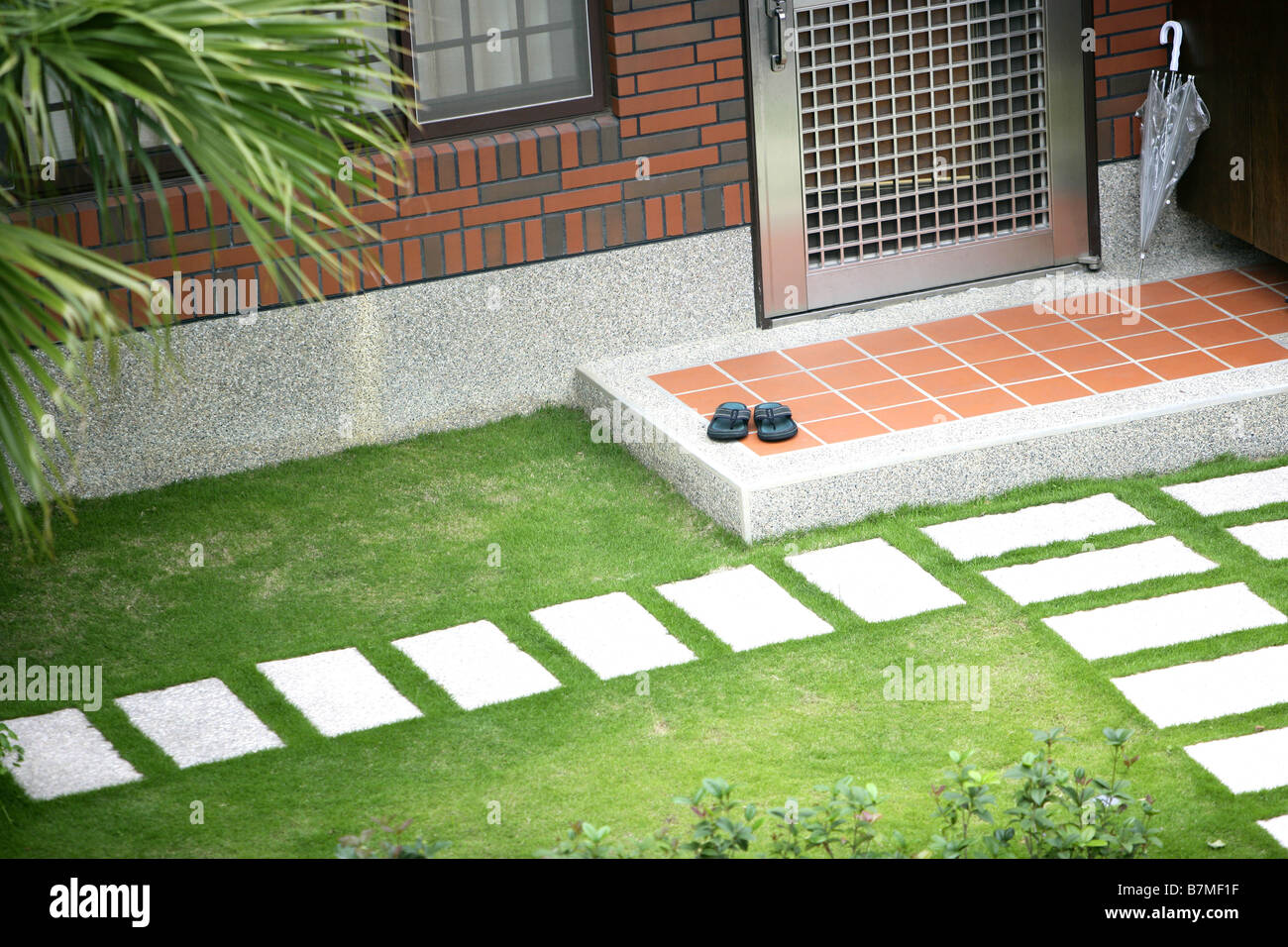 View of front door with grass and stone steps Stock Photo - Alamy