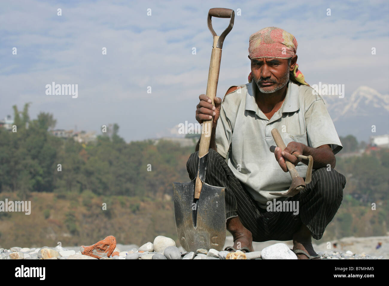 Man with hand tools sand quarry Stock Photo - Alamy