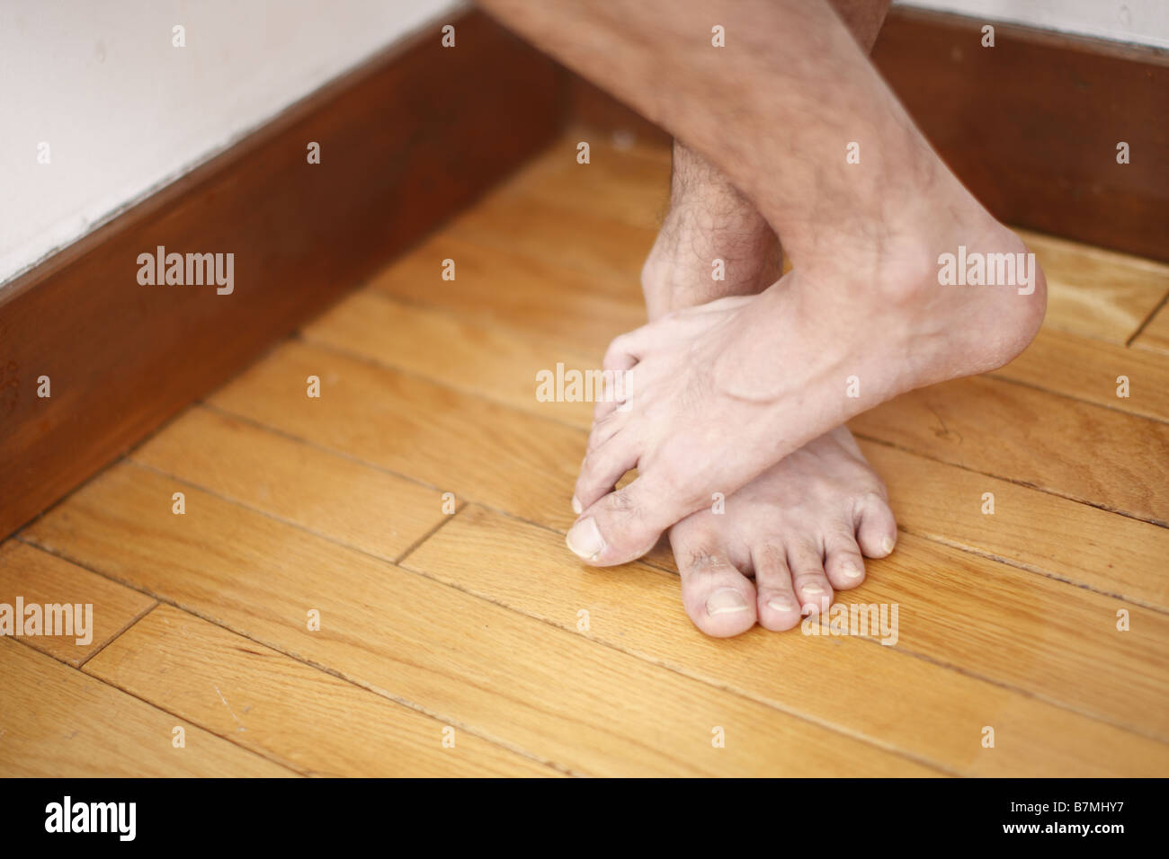 Feet on Wooden Floor Stock Photo - Alamy