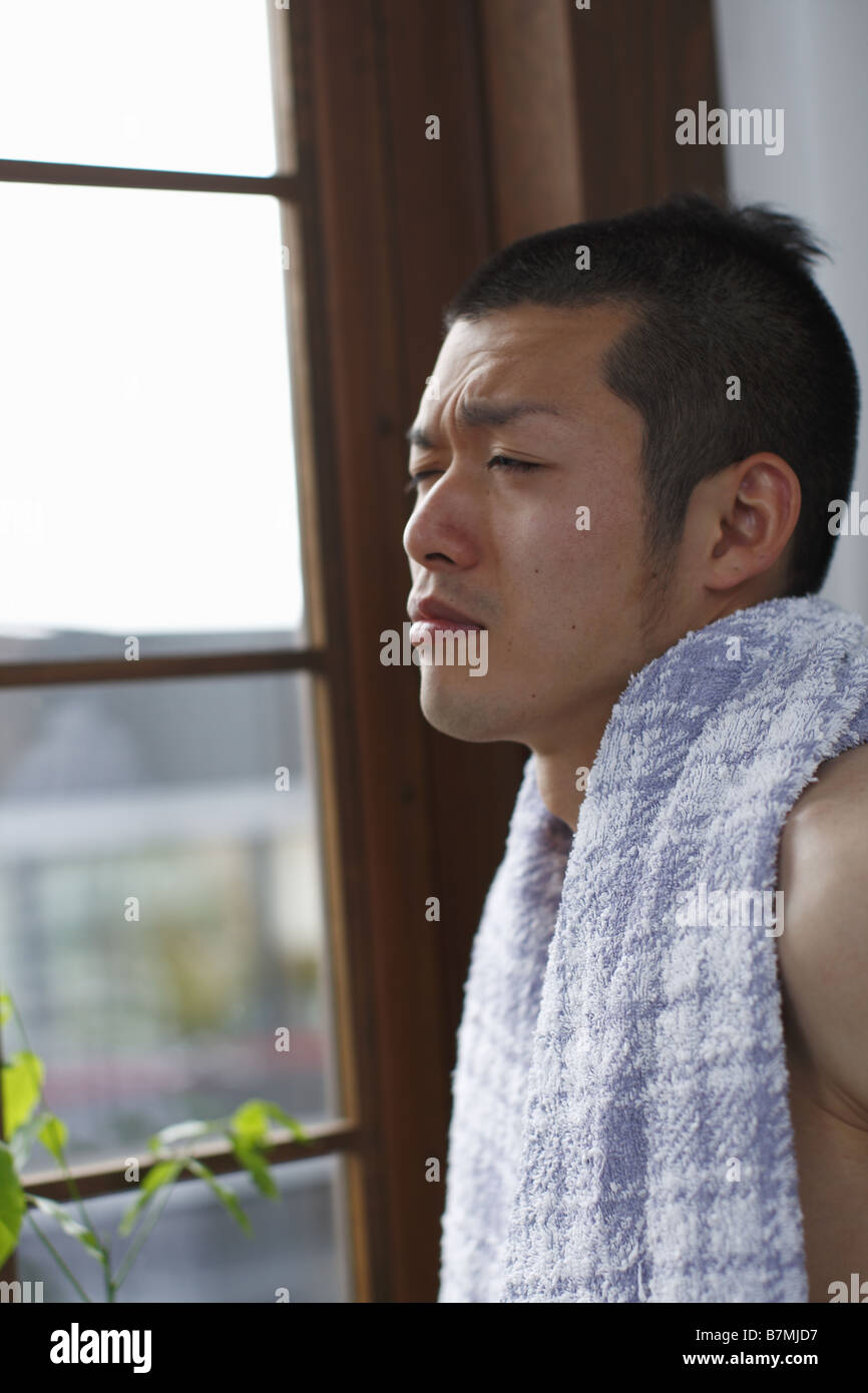 Man Standing next to Window Stock Photo - Alamy