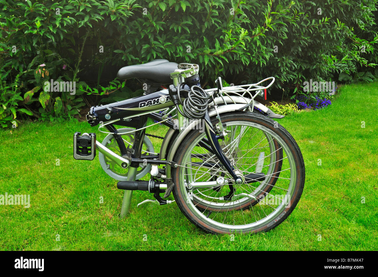 A folding bicycle folded up Stock Photo - Alamy