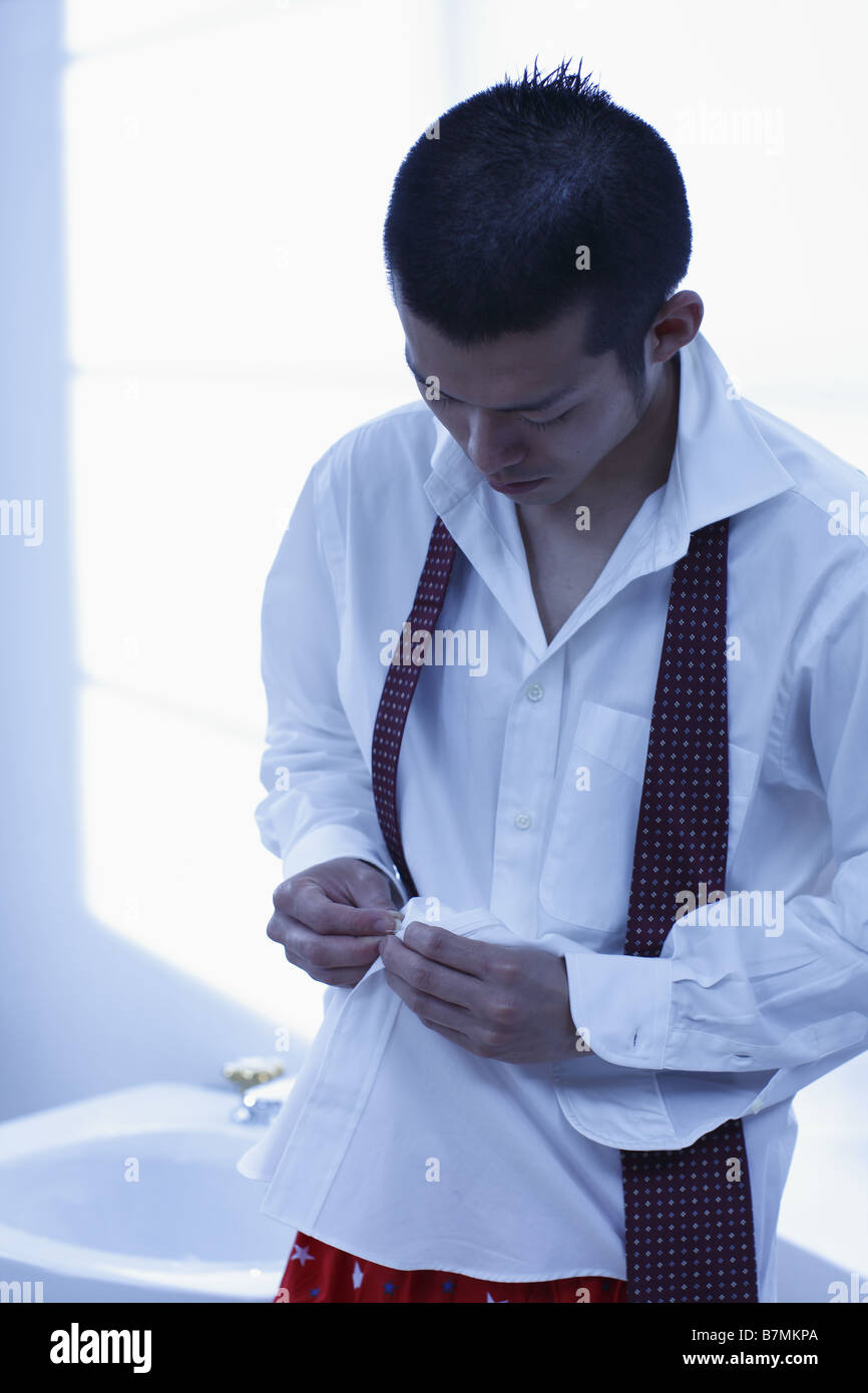 Man Buttoning Shirt Stock Photo - Alamy