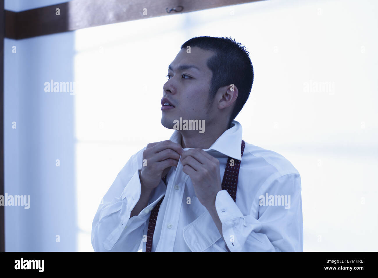 Man Buttoning Shirt Stock Photo - Alamy