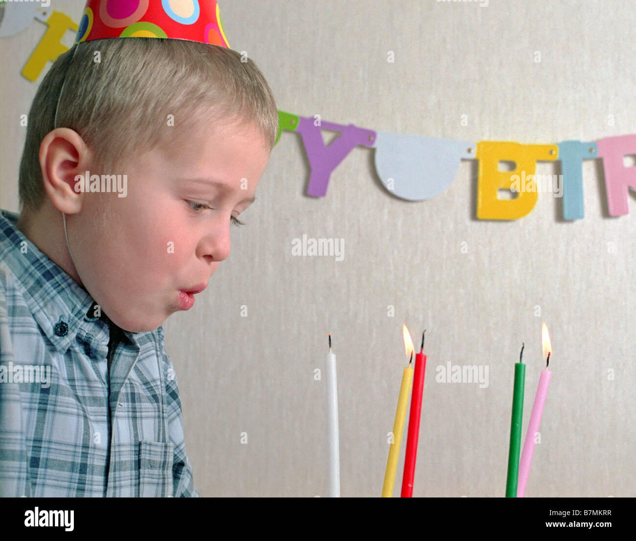 child blowing birthday cake Stock Photo - Alamy