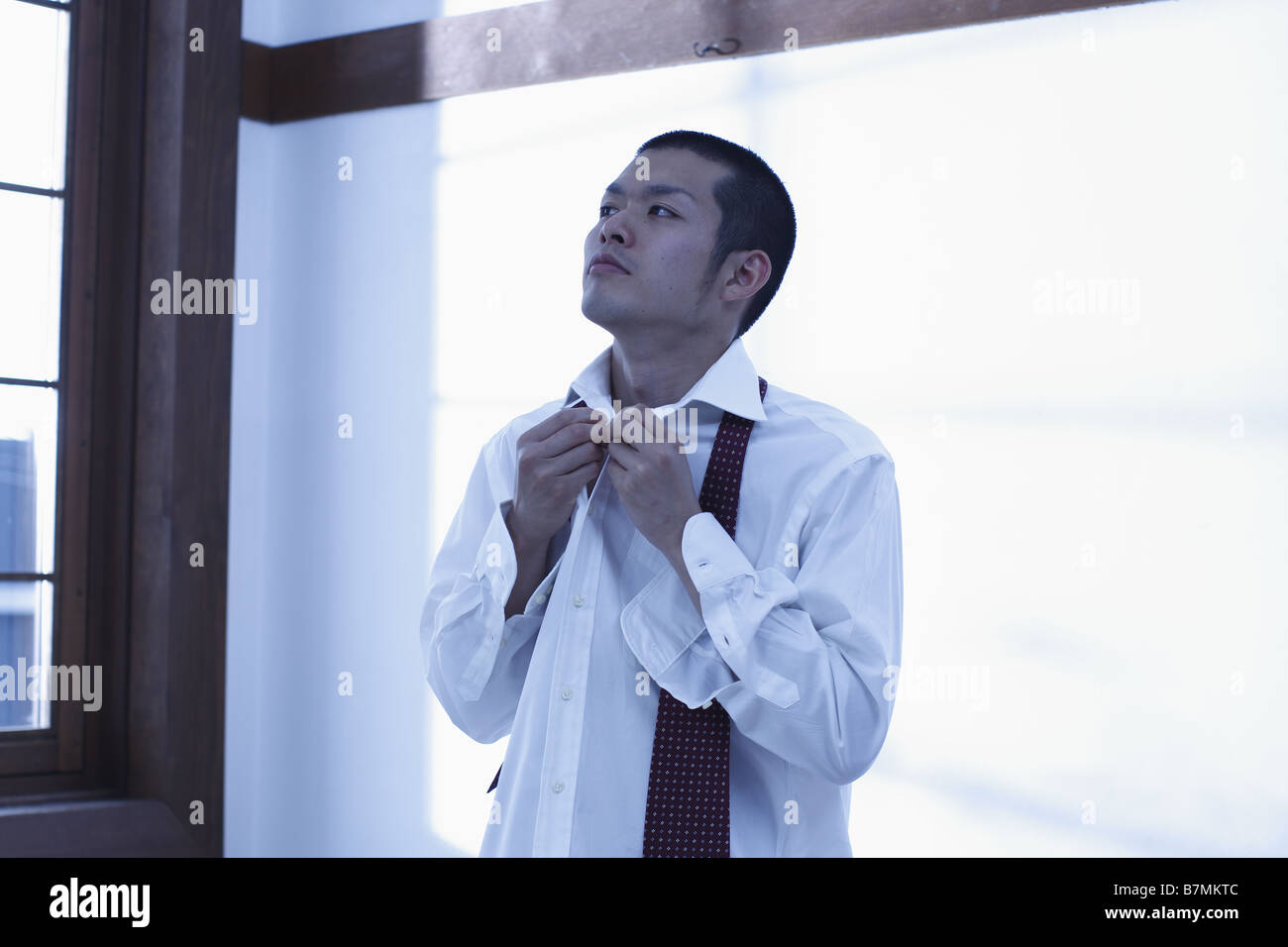 Man Buttoning Shirt Stock Photo - Alamy
