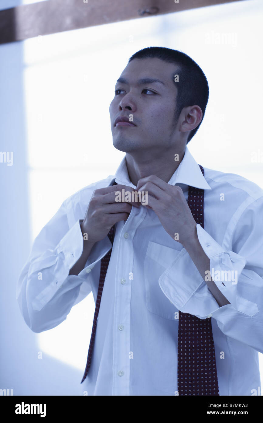 Man Buttoning Shirt Stock Photo - Alamy