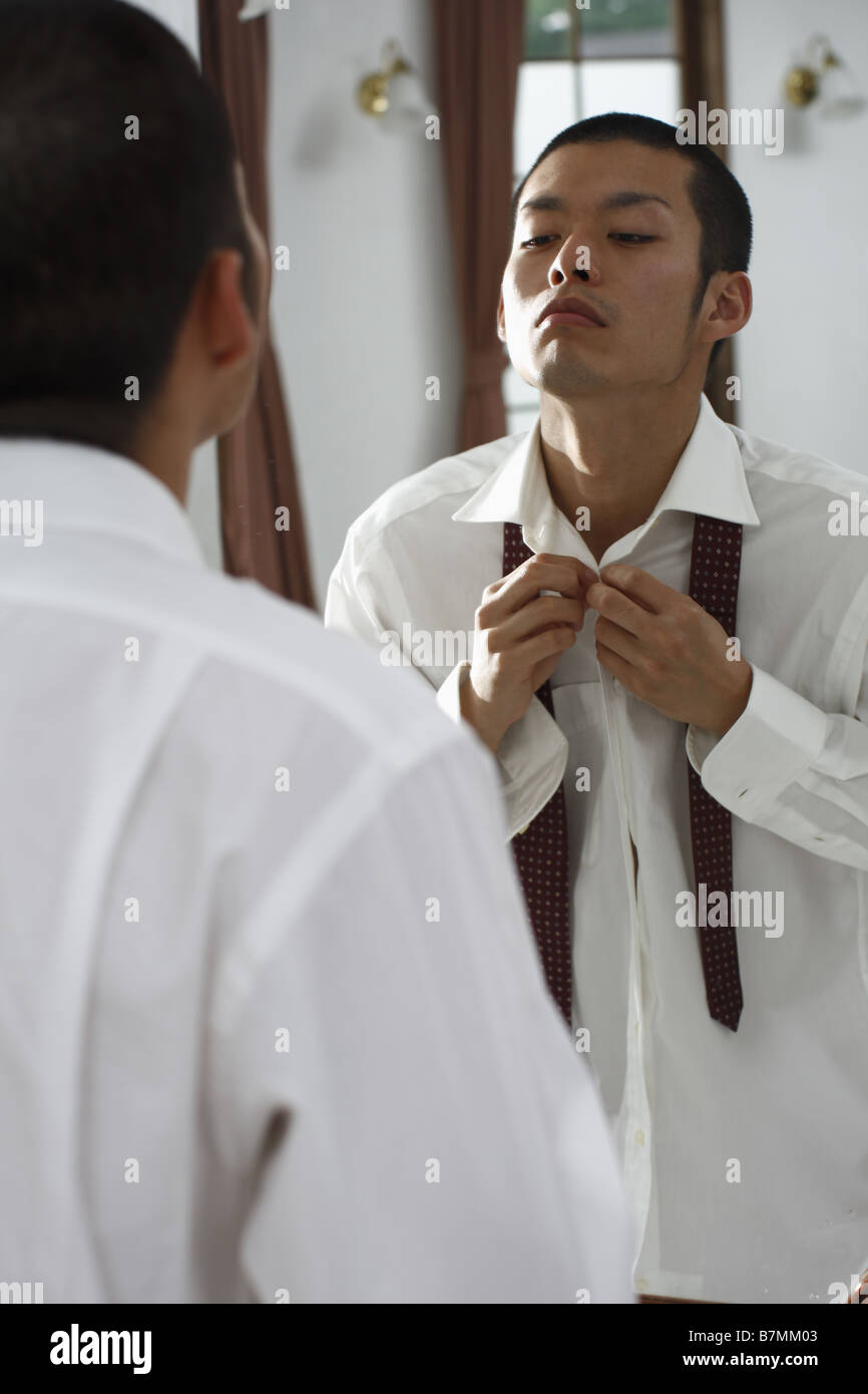 Man Buttoning Shirt Stock Photo - Alamy
