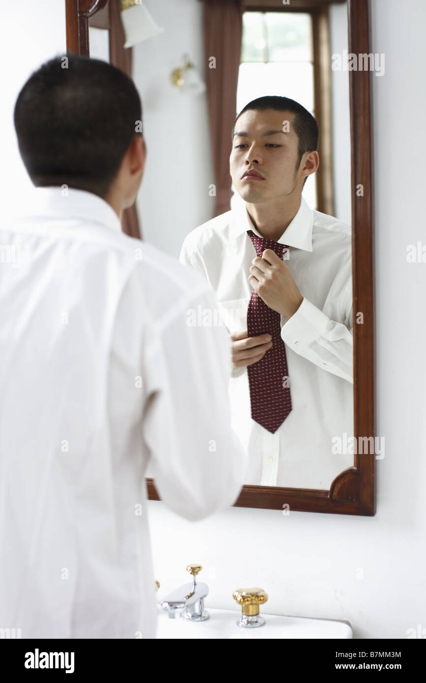 Man Adjusting His Tie Stock Photo - Alamy