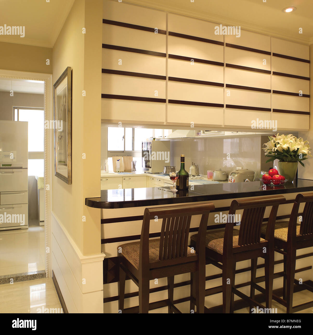 View of empty modern kitchen and dining room Stock Photo - Alamy