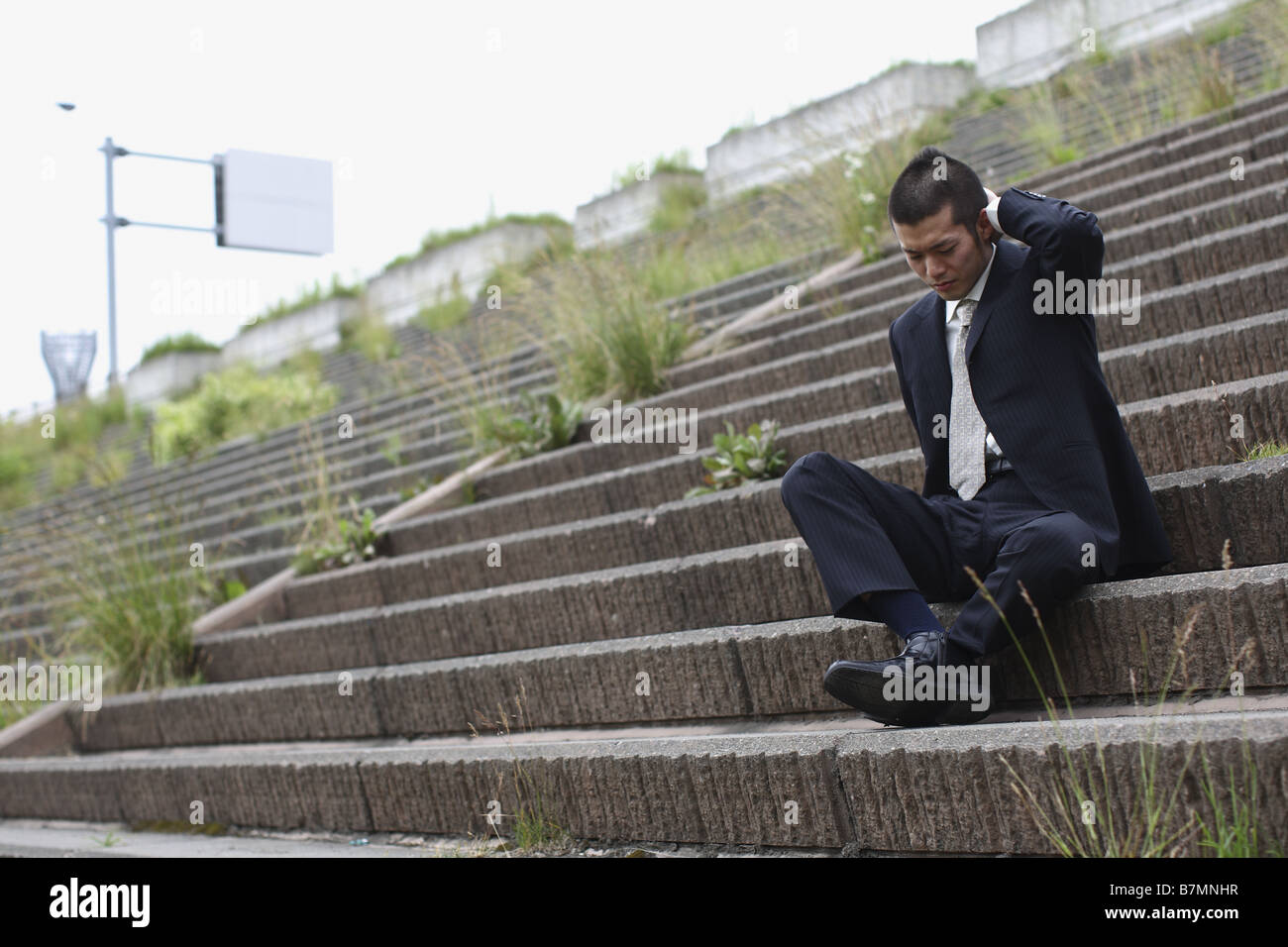 Tired Businessman Sitting on Steps Stock Photo - Alamy