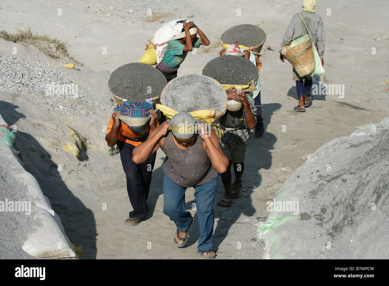 Man carrying sand quarry Stock Photo - Alamy