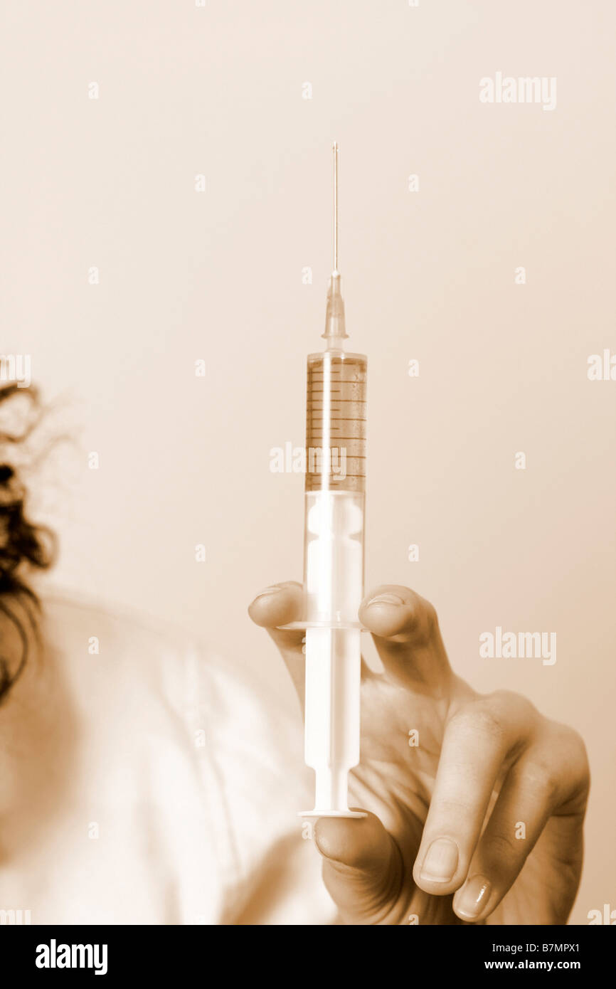 Portrait of a young doctor with syringe Stock Photo - Alamy