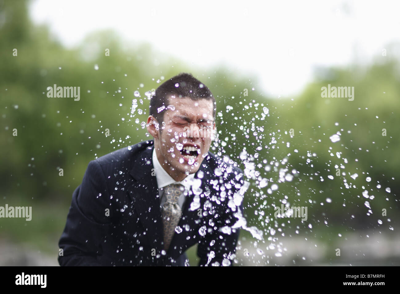 Businessman Shouting and Splashing by River Bank Stock Photo - Alamy