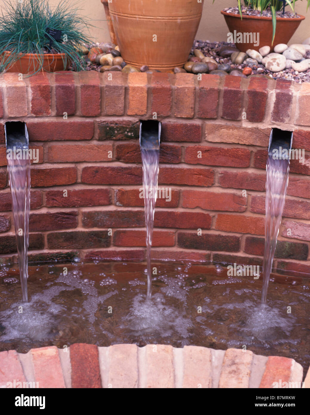 WATER FALLS SET INTO BRICK WALL Stock Photo - Alamy
