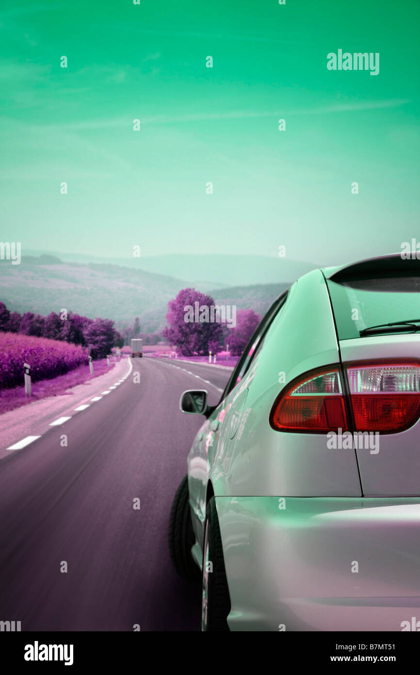 Car on the road view from the back Stock Photo - Alamy