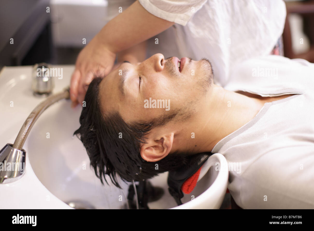 Man Having Hair Washed Stock Photo - Alamy