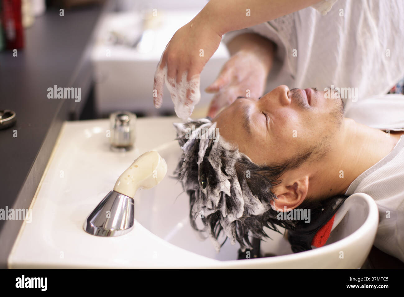 Man Having Hair Washed Stock Photo - Alamy