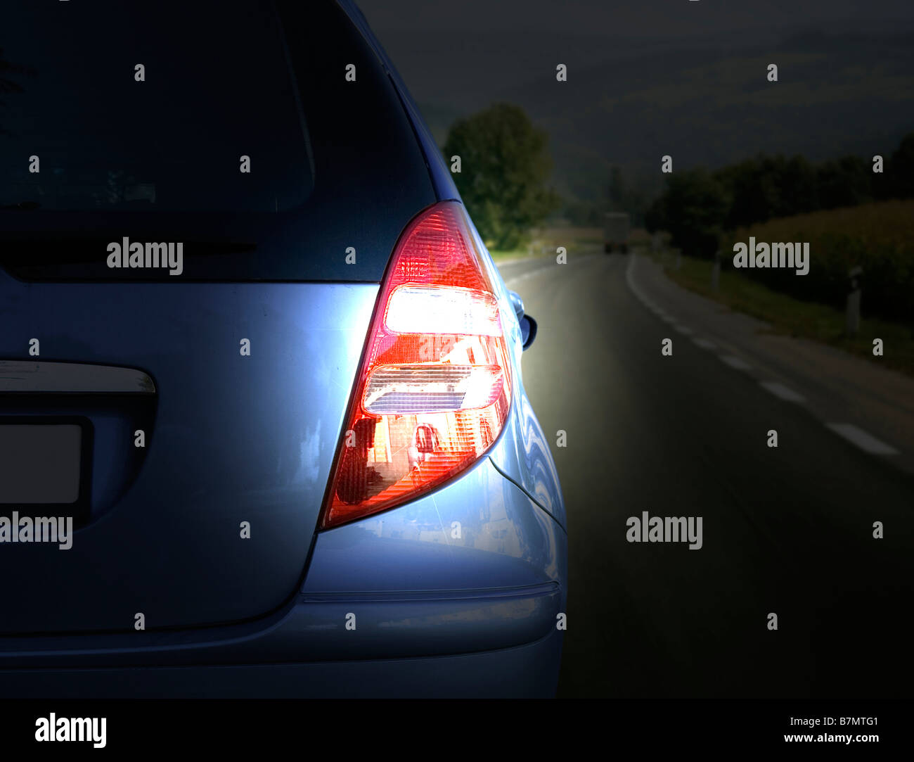 Blue car on the road Stock Photo - Alamy