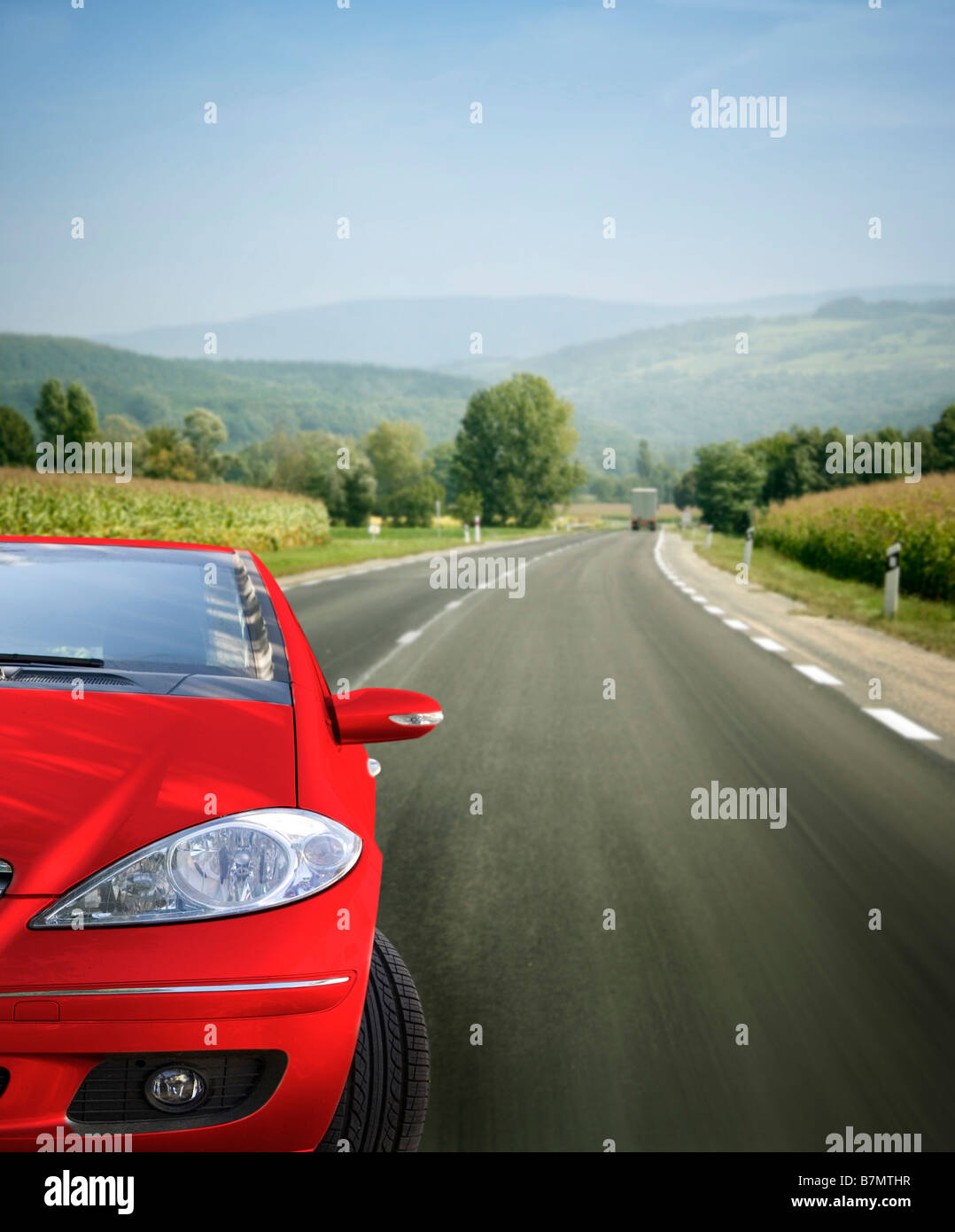 Red car on the road Stock Photo - Alamy