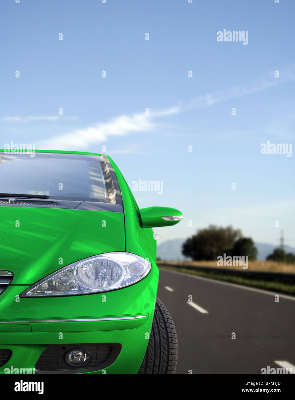 Green car on the road Stock Photo - Alamy
