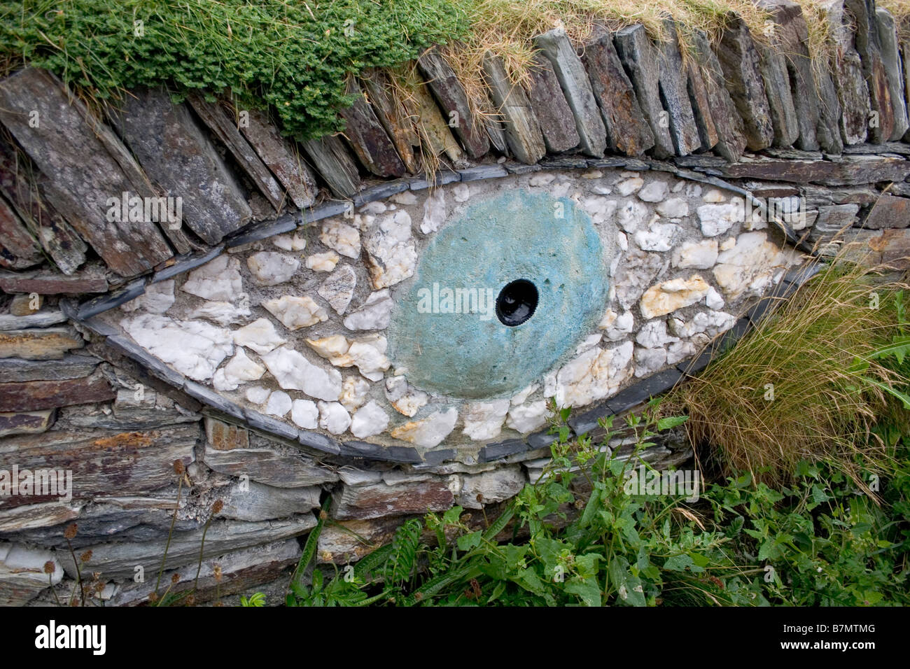 eye art in a dry stone wall Stock Photo - Alamy