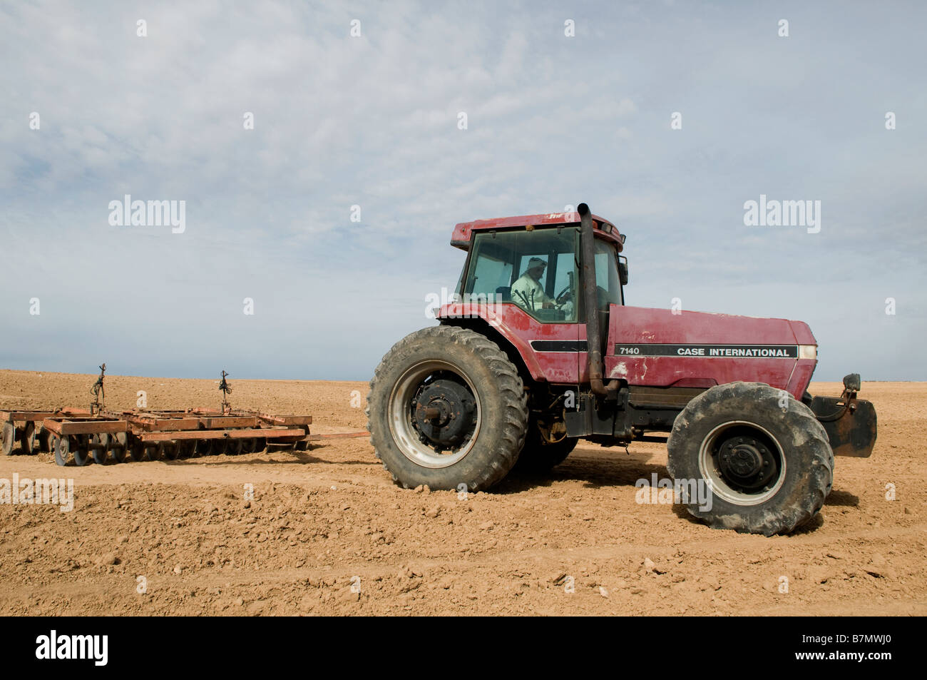 Israeli Bedouin Arab working in the field with a farm tractor. Negev ...