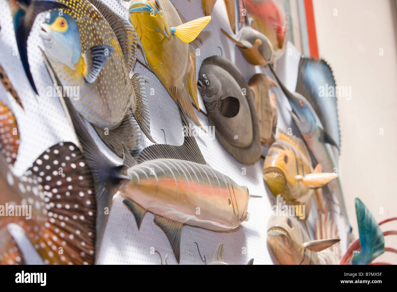 Close-up of painted wooden fish souvenirs on sale for tourists in ...