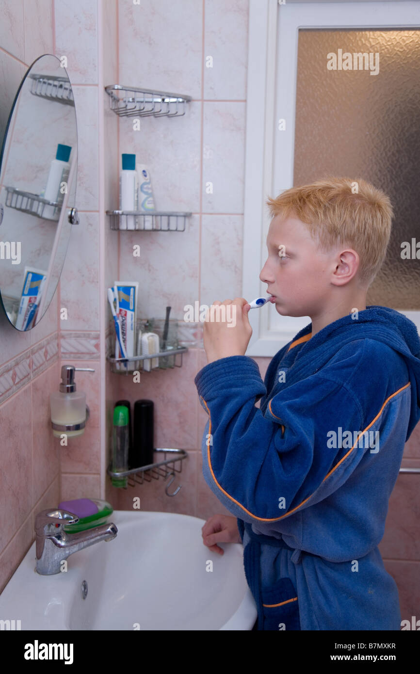Teenage Boy Brushing Teeth in Bathroom Stock Photo - Alamy