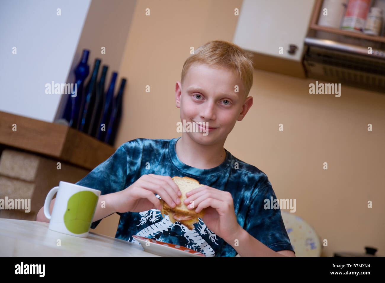 Teenage Boy Eating Breakfast in Kitchen Stock Photo - Alamy