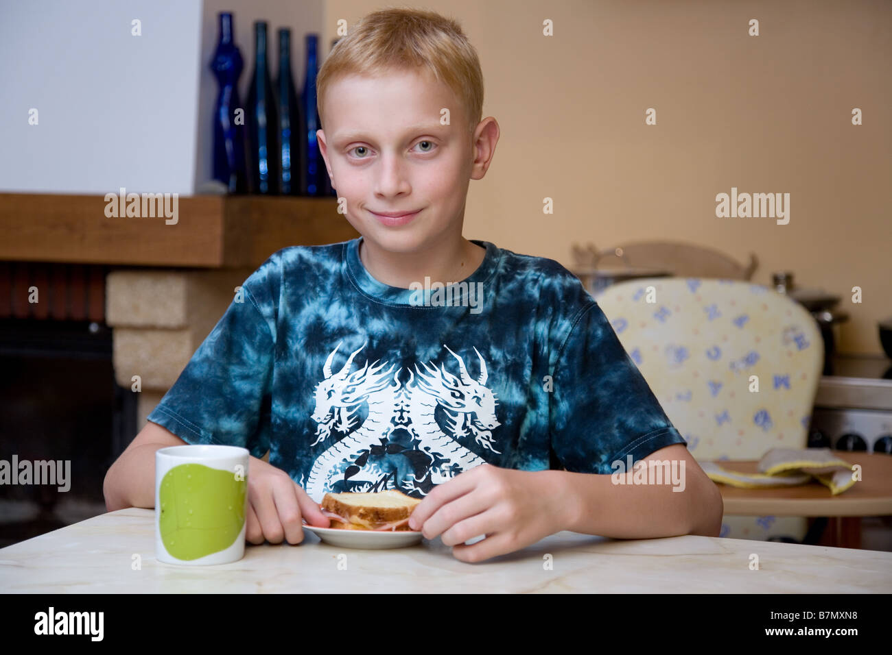 Teenage Boy Eating Breakfast in Kitchen Stock Photo - Alamy
