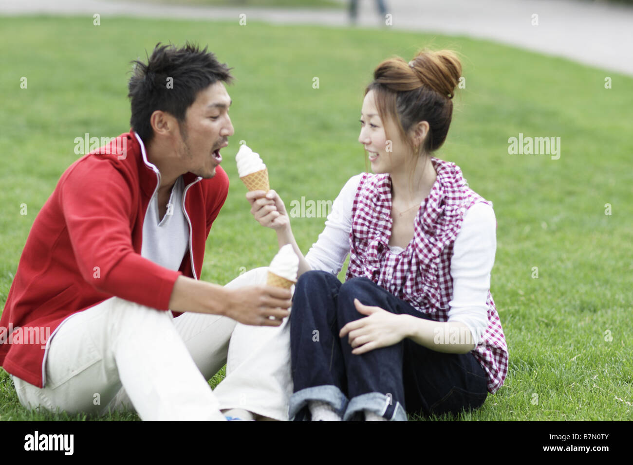 Woman Feeding Boyfriend Soft Serve Ice Cream Stock Photo - Alamy