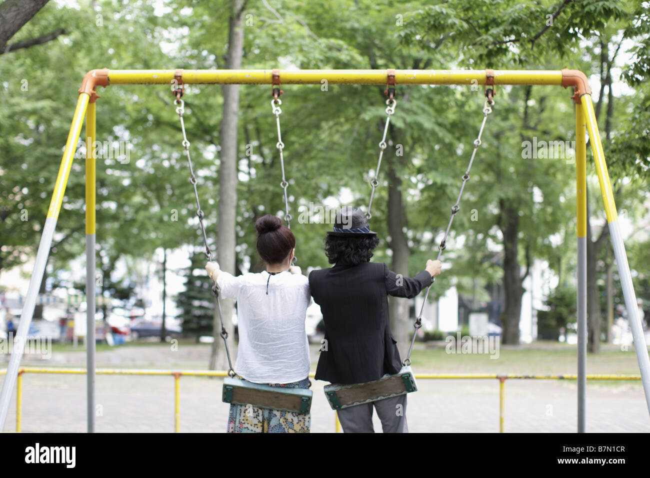 Couple on Swing Stock Photo - Alamy
