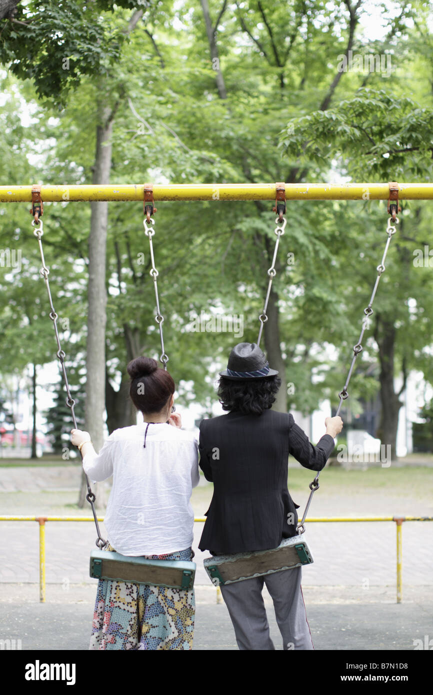 Couple on Swing Stock Photo - Alamy