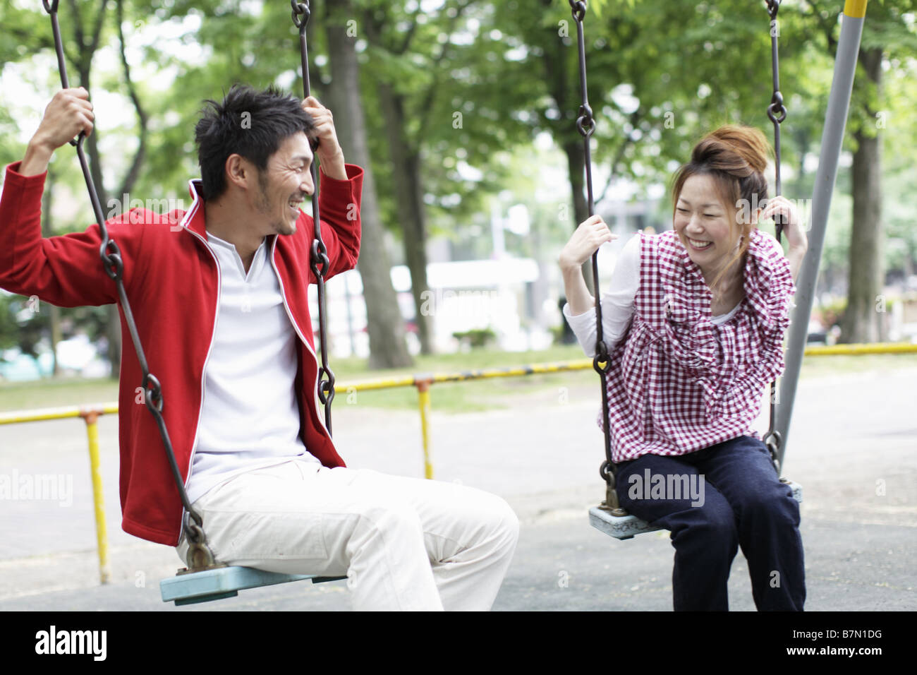 Couple on Swing Stock Photo - Alamy