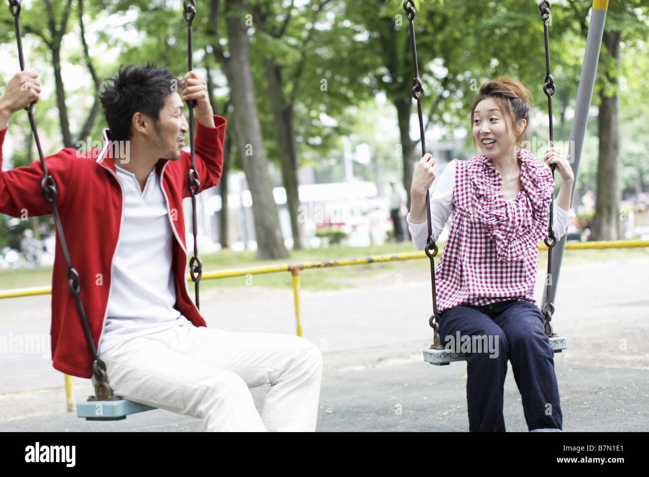 Couple on Swing Stock Photo - Alamy