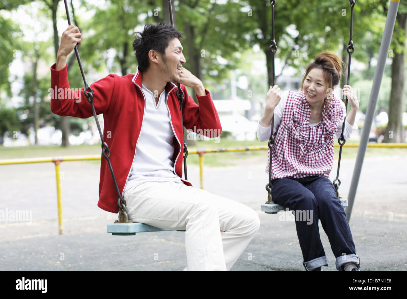 Couple on Swing Stock Photo - Alamy