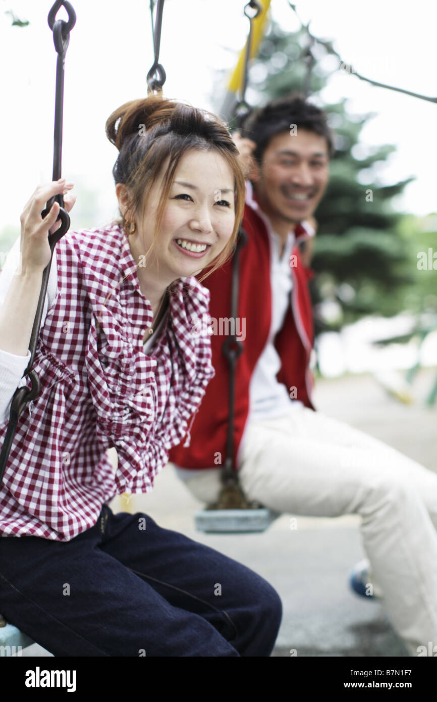 Couple on Swing Stock Photo - Alamy