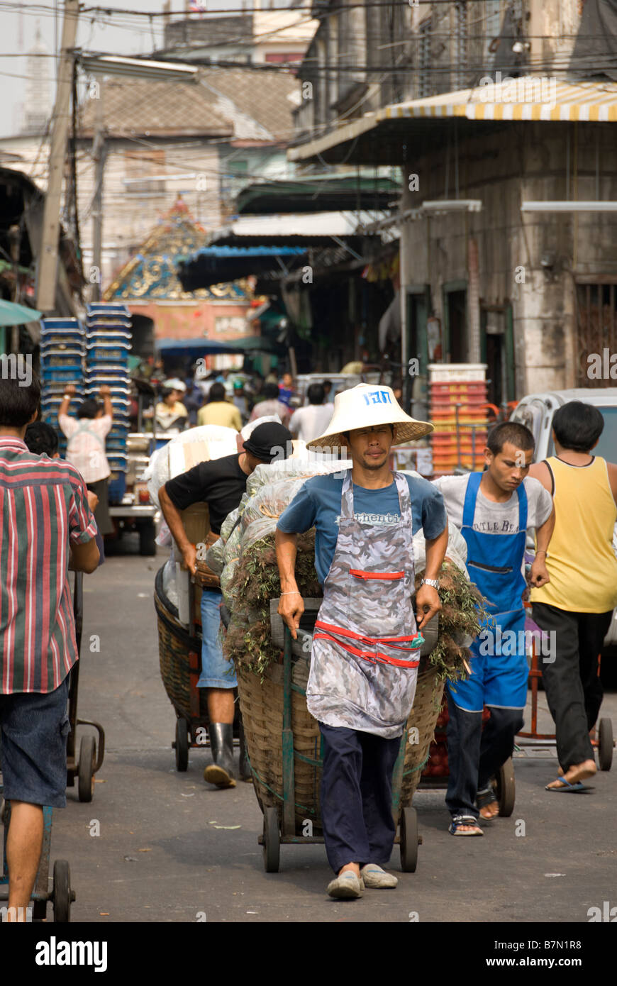 Porter transporting vegetables with a sack truck Pak Khlong Talad fresh ...