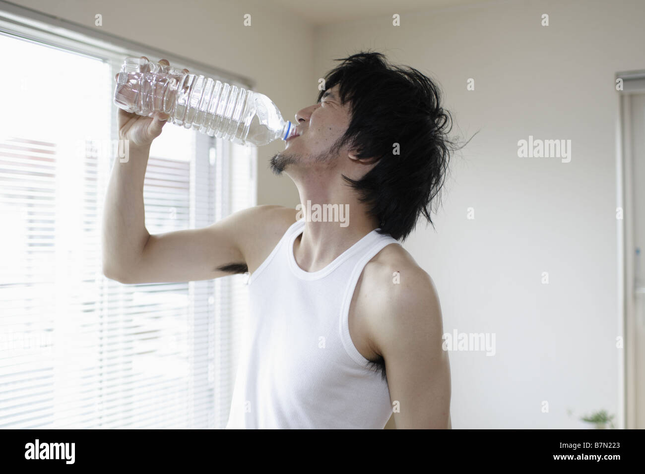 Man Taking a Bottle of Water Stock Photo - Alamy