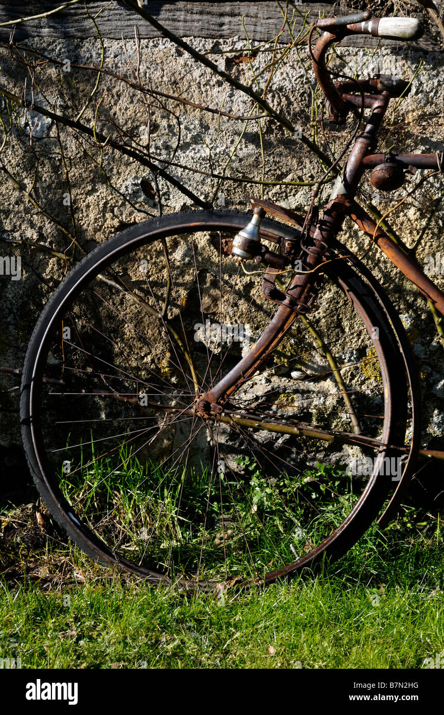 Stock photo of a very old rusty bike left leaning against a wall Stock ...