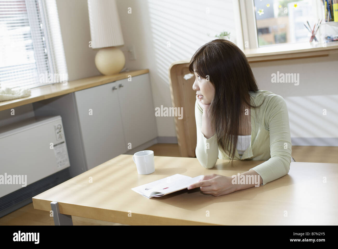 Woman Reading a Book at Home Stock Photo - Alamy