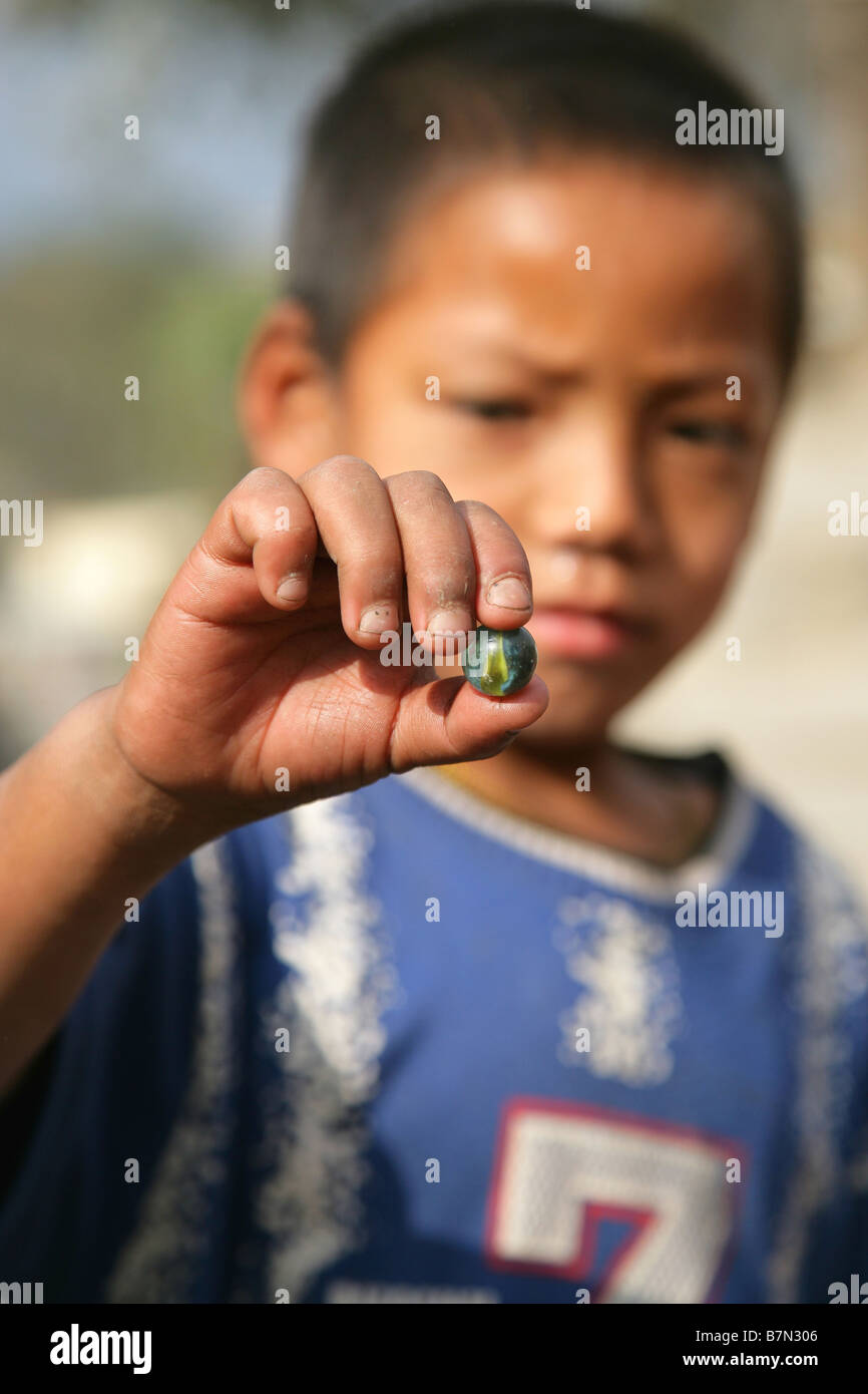 Boy holding a marble Stock Photo - Alamy