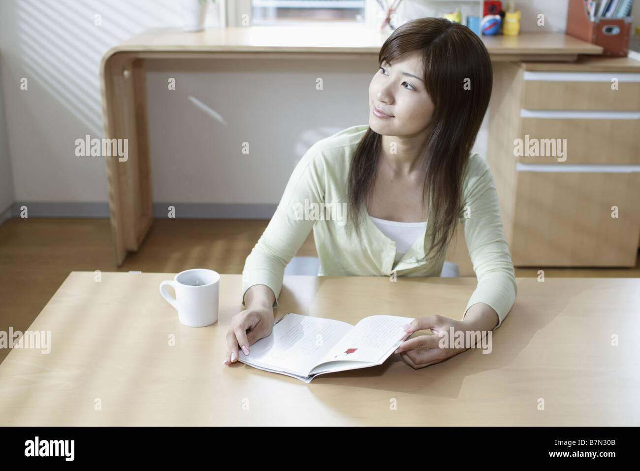 Woman Reading a Book at Home Stock Photo - Alamy