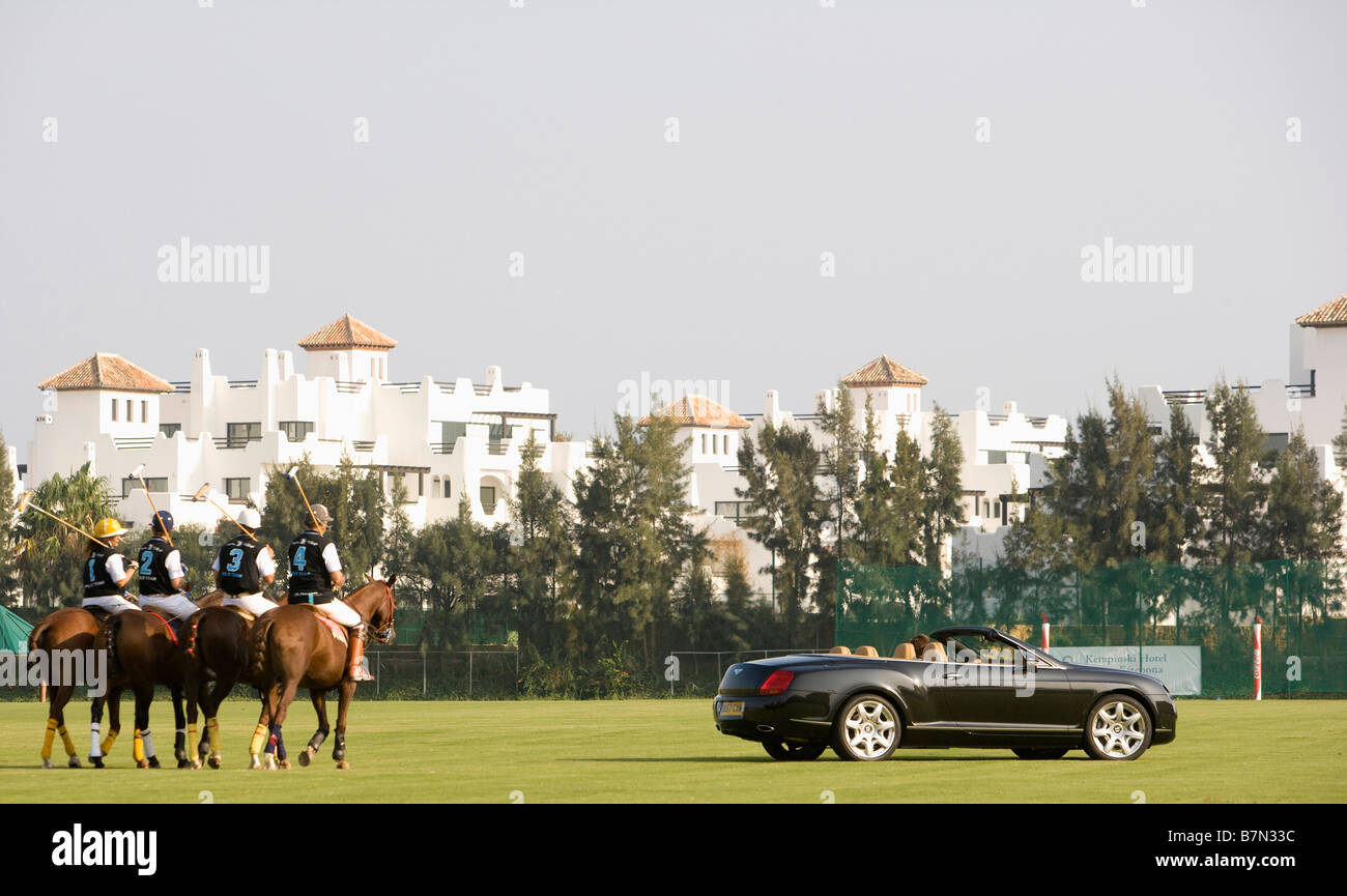 Riders on polo ponies on ground with holiday villas in background at ...