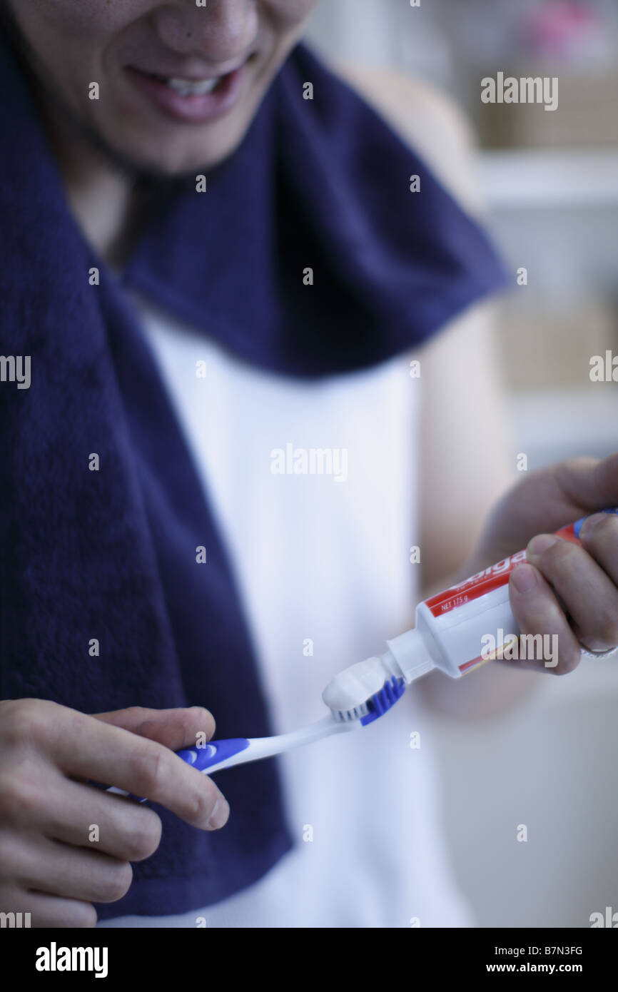 Man Putting Toothpaste on Toothbrush Stock Photo - Alamy