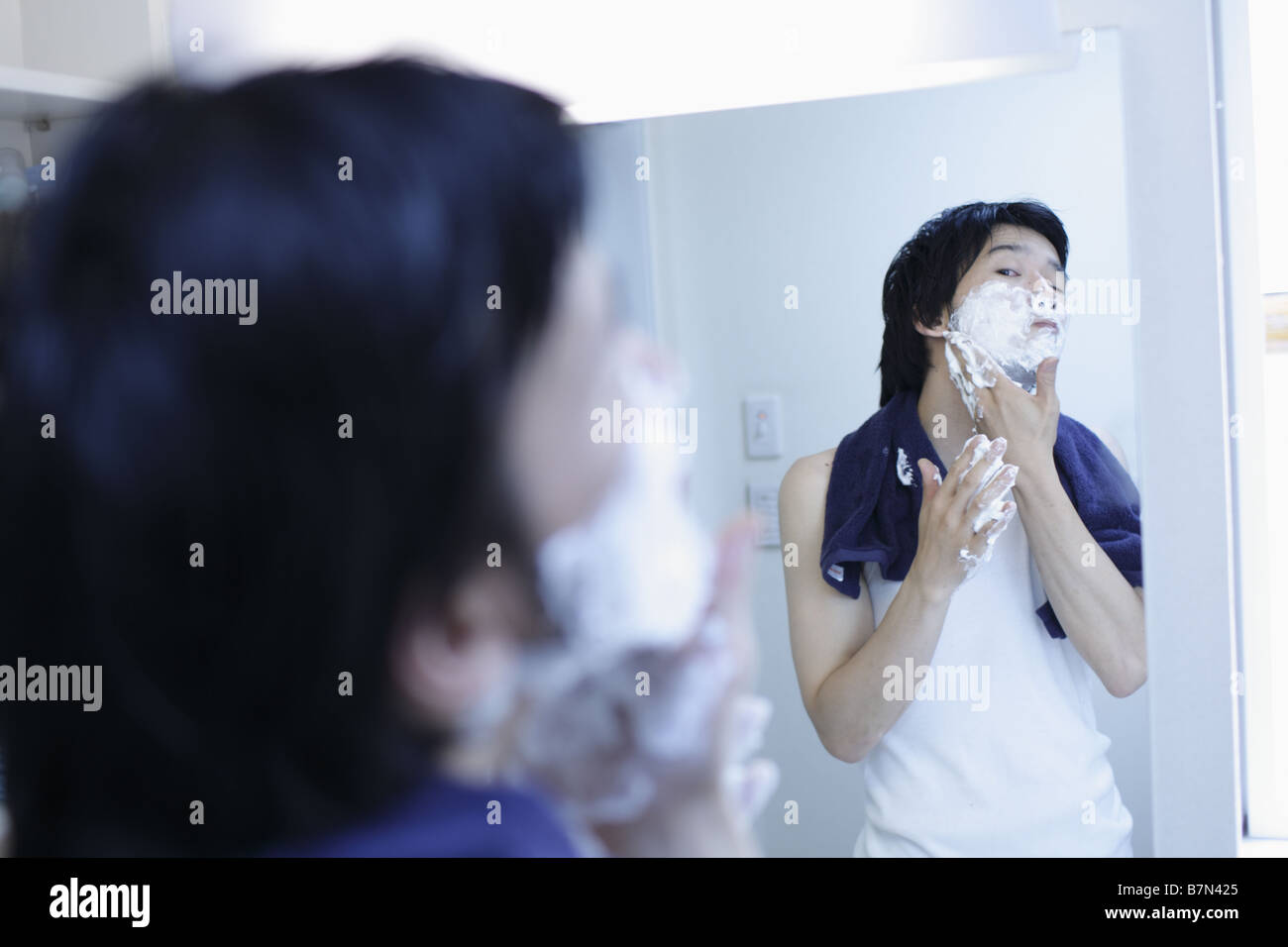 Man Shaving in a Bathroom Stock Photo - Alamy