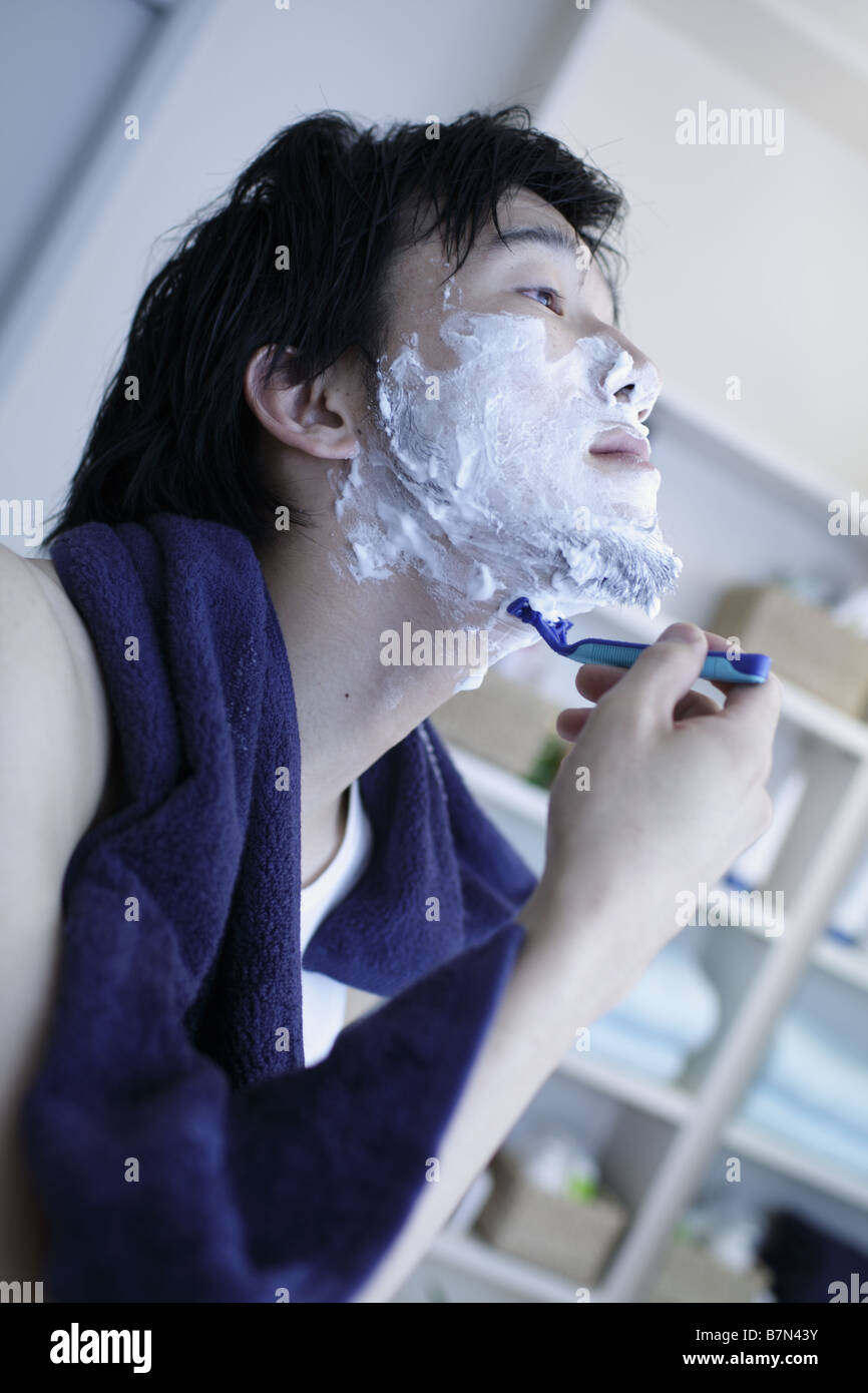 Man Shaving in a Bathroom Stock Photo - Alamy