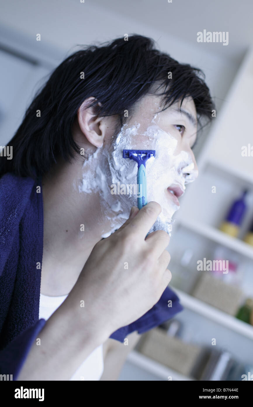 Man Shaving in a Bathroom Stock Photo - Alamy