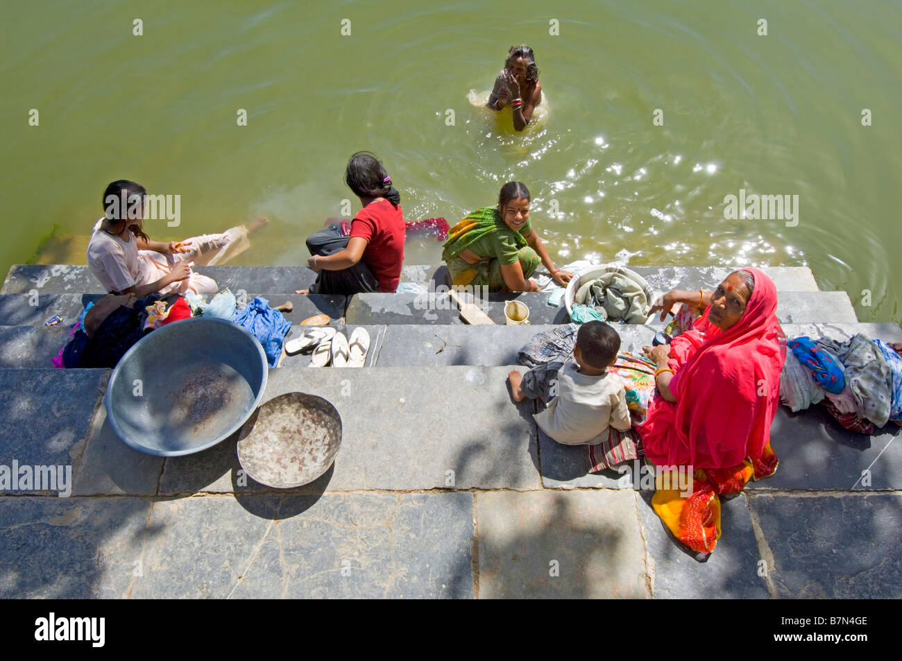 Young indian woman washing clothes hi-res stock photography and images ...